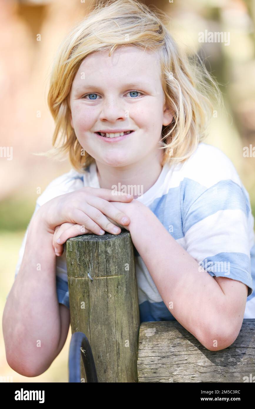 Boy leaning on fence hi-res stock photography and images - Alamy