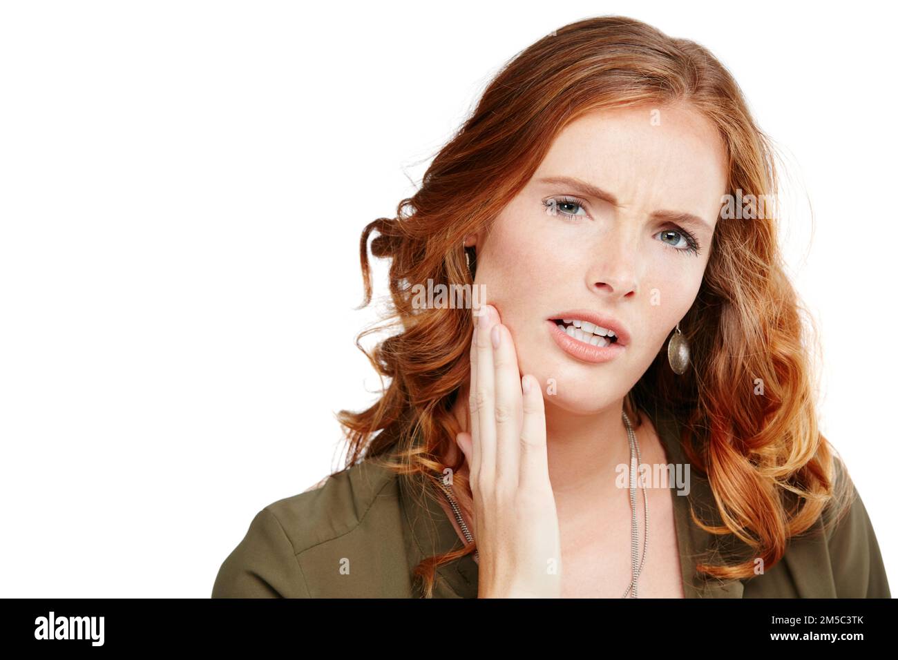 Do you know of any remedies for toothache. Studio shot of a young woman ...