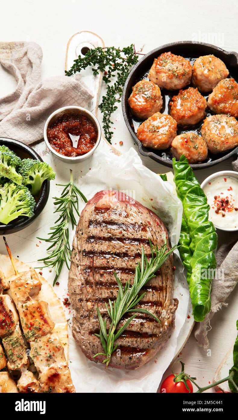 Various types of healthy cooked meat - beef, pork, chicken on a light ...