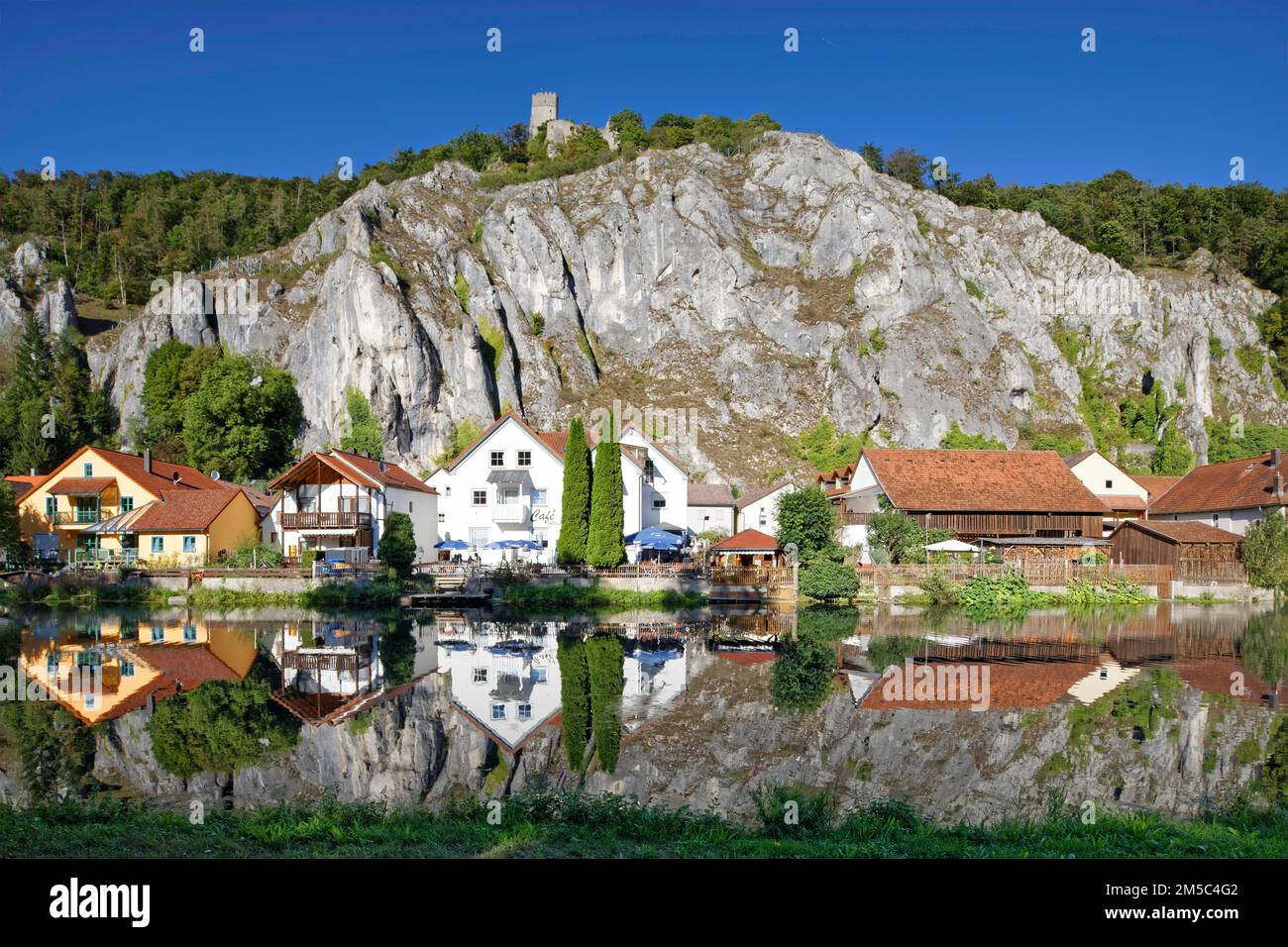 Side arm of the Altmuehl, houses, reflection in the water, on top of ...