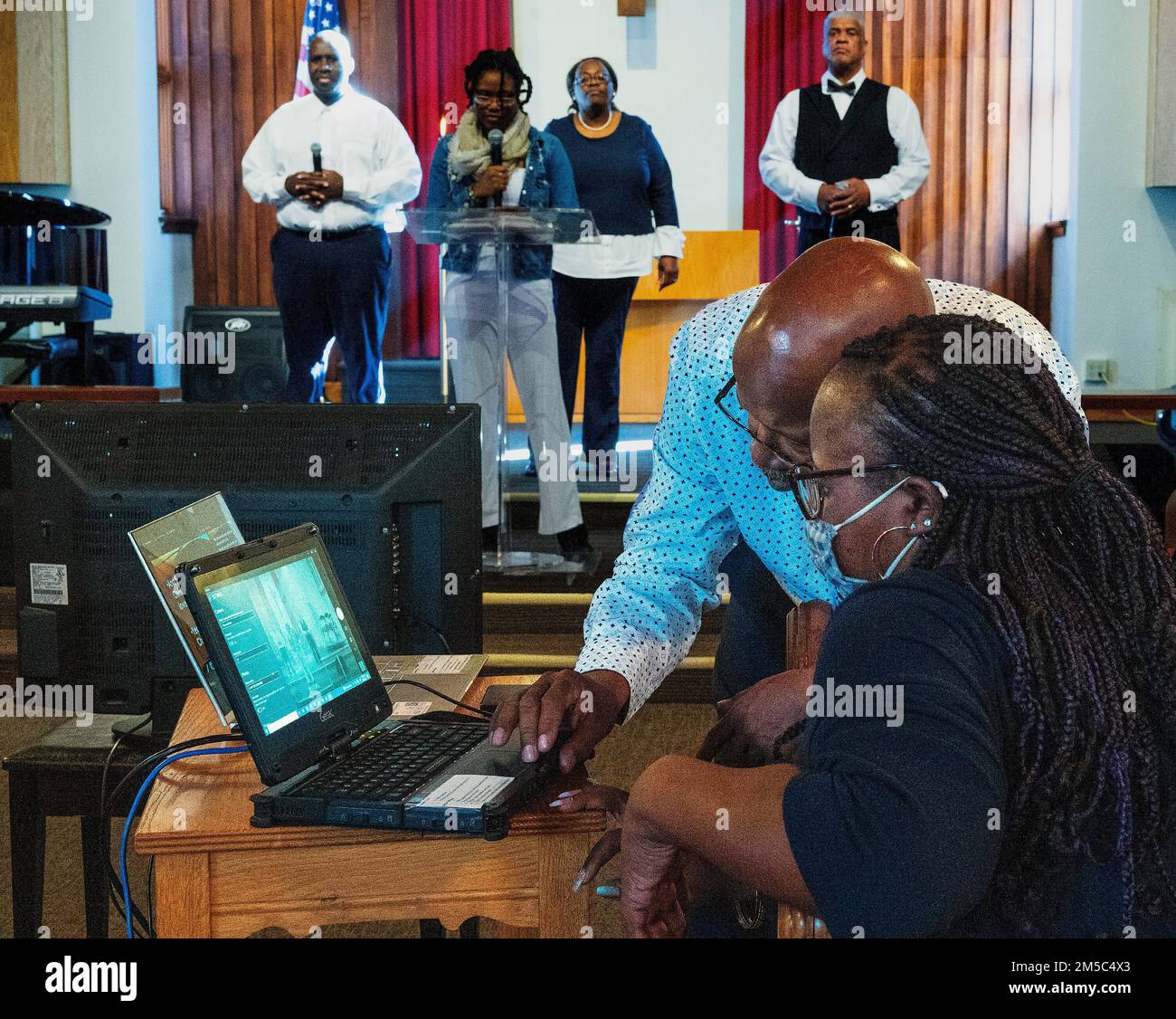 Brandi and Bryant Gillespie monitor the Protestant service video ...