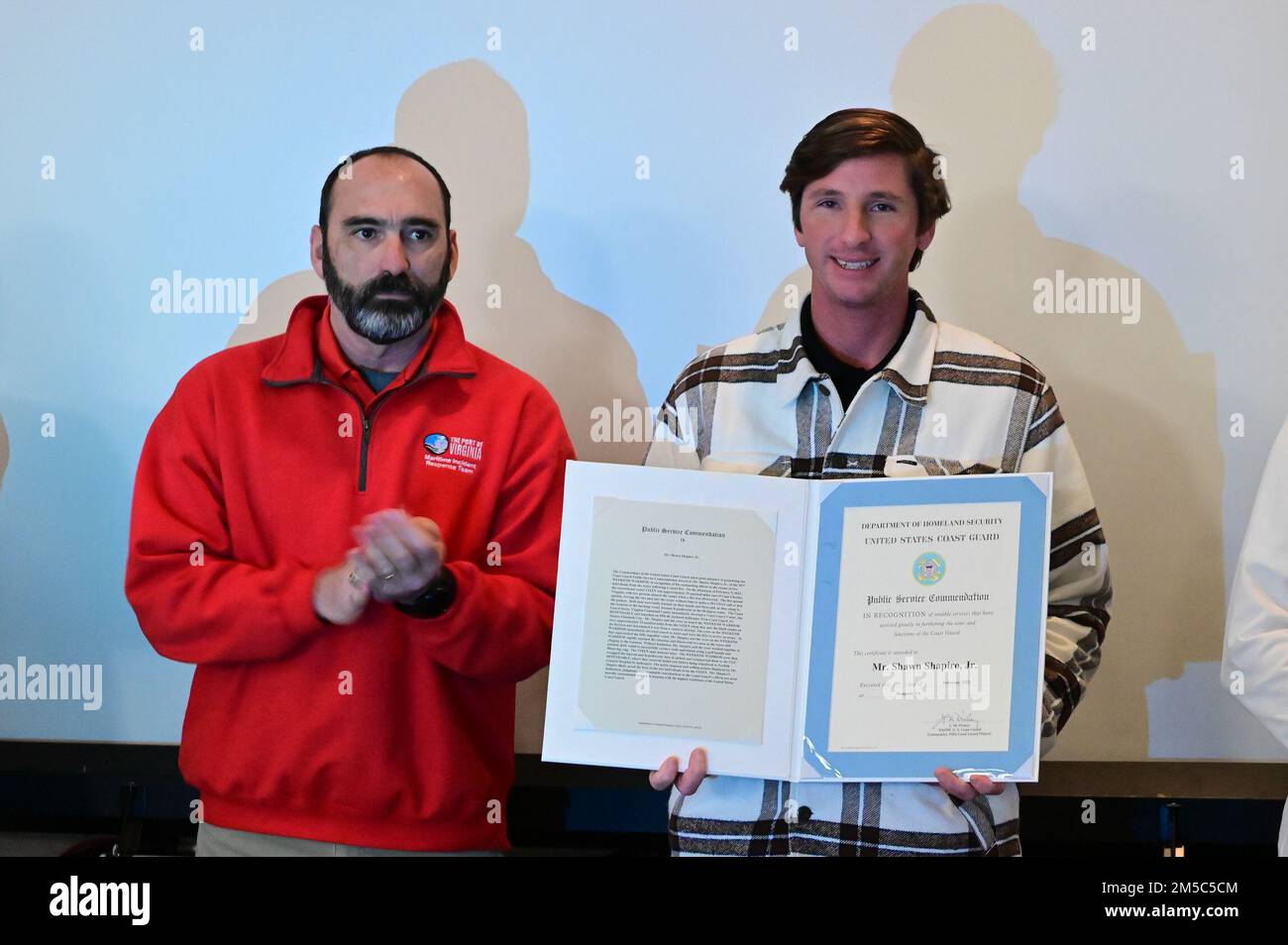Shawn Shapiro Jr. smiles holding his Coast Guard Public Service ...