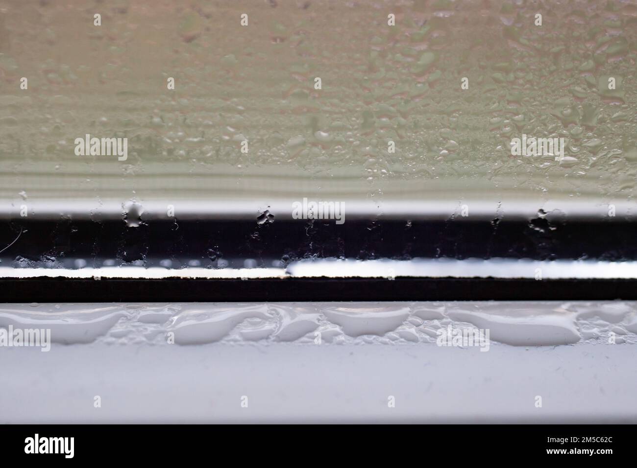 Water drops on a window frame, moisture inside the house, soft focus ...