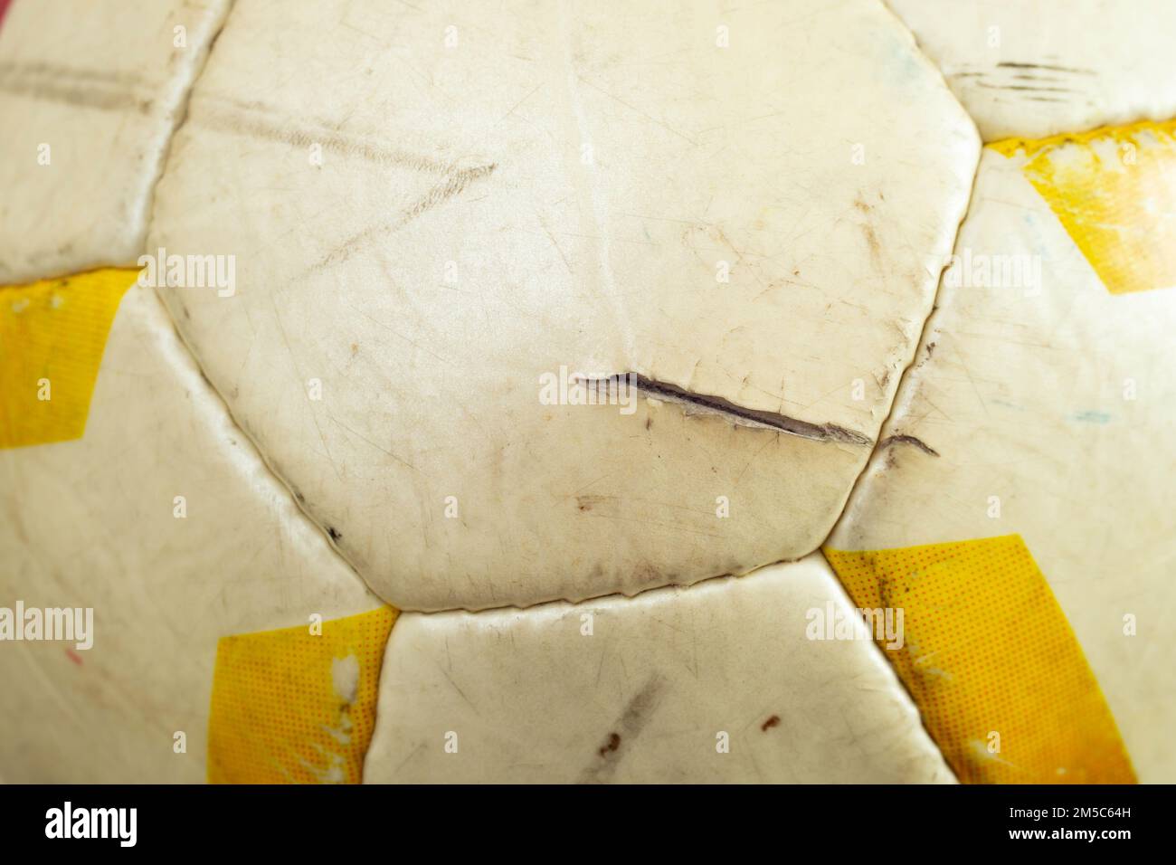 used and cracked soccer ball, soft focus close up Stock Photo - Alamy
