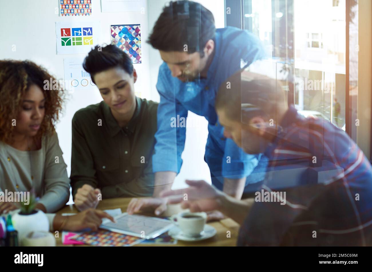 Making a plan of action. a group of coworkers discussing something on a ...