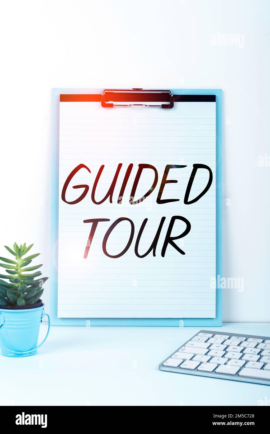 Hand writing sign Guided Tour. Word for advice or information aimed at ...