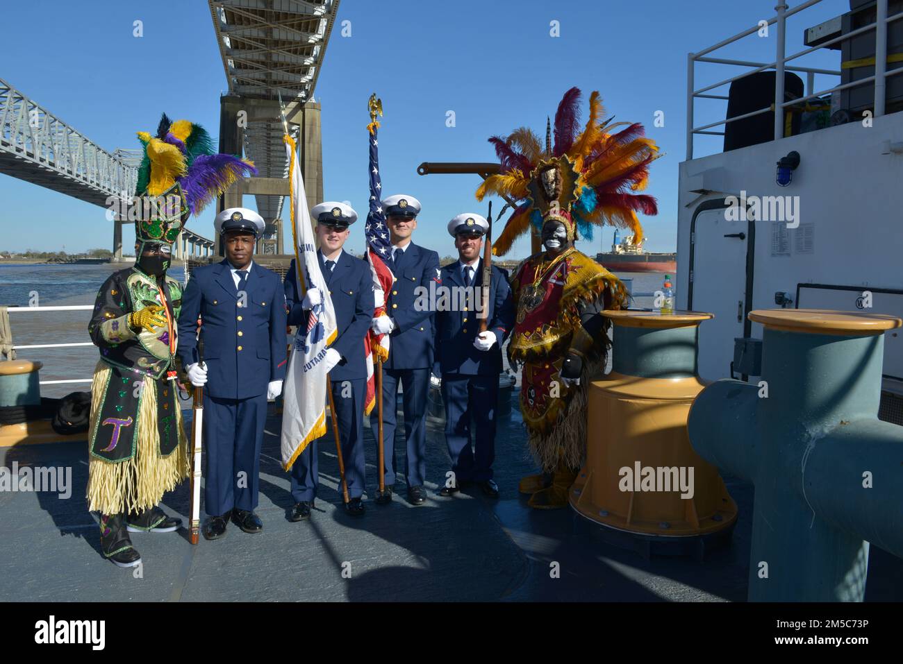 Members of the U.S. Coast Guard color guard stand with members of the ...