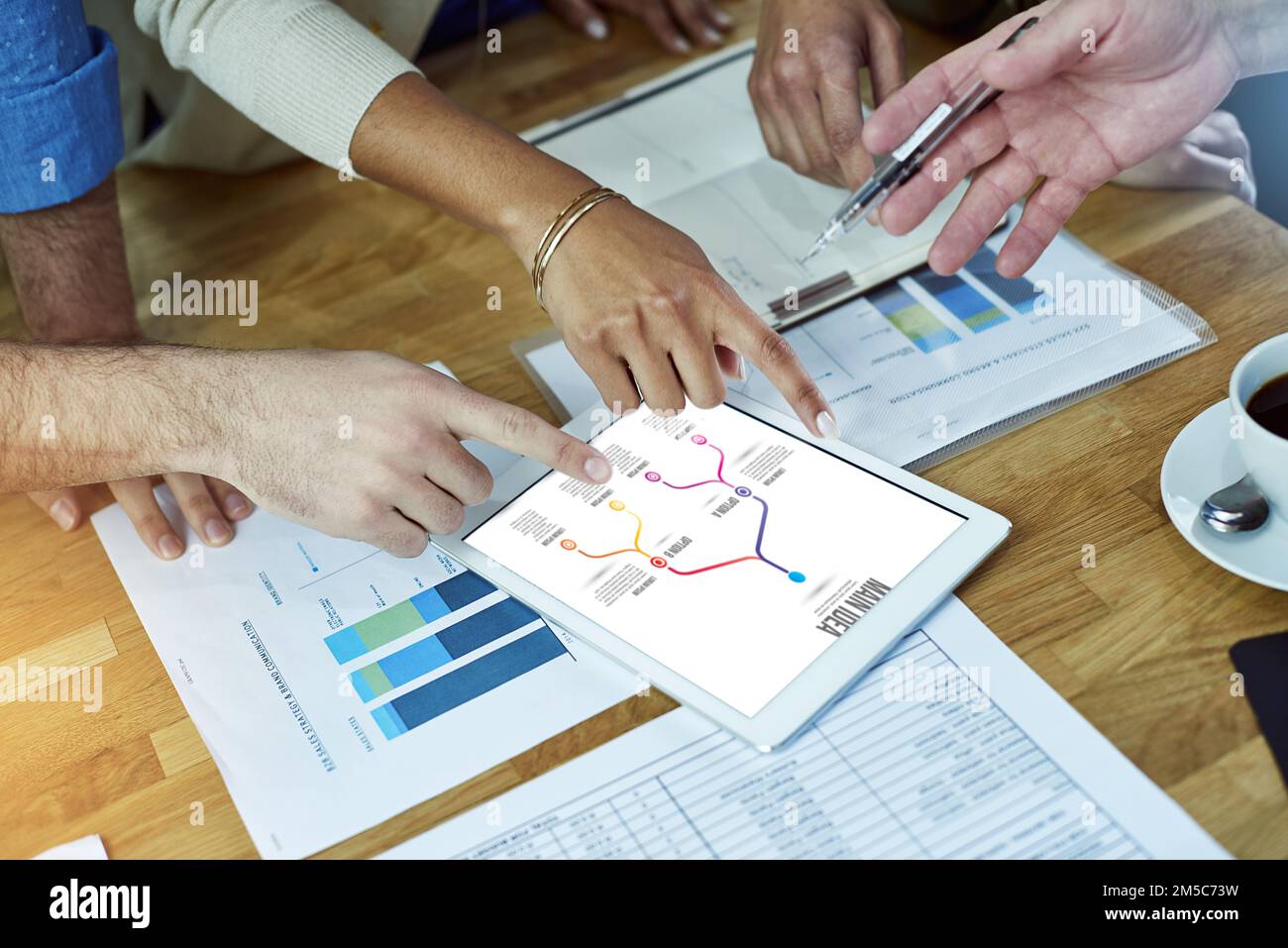 Covering all aspects. coworkers discussing statistics Stock Photo - Alamy