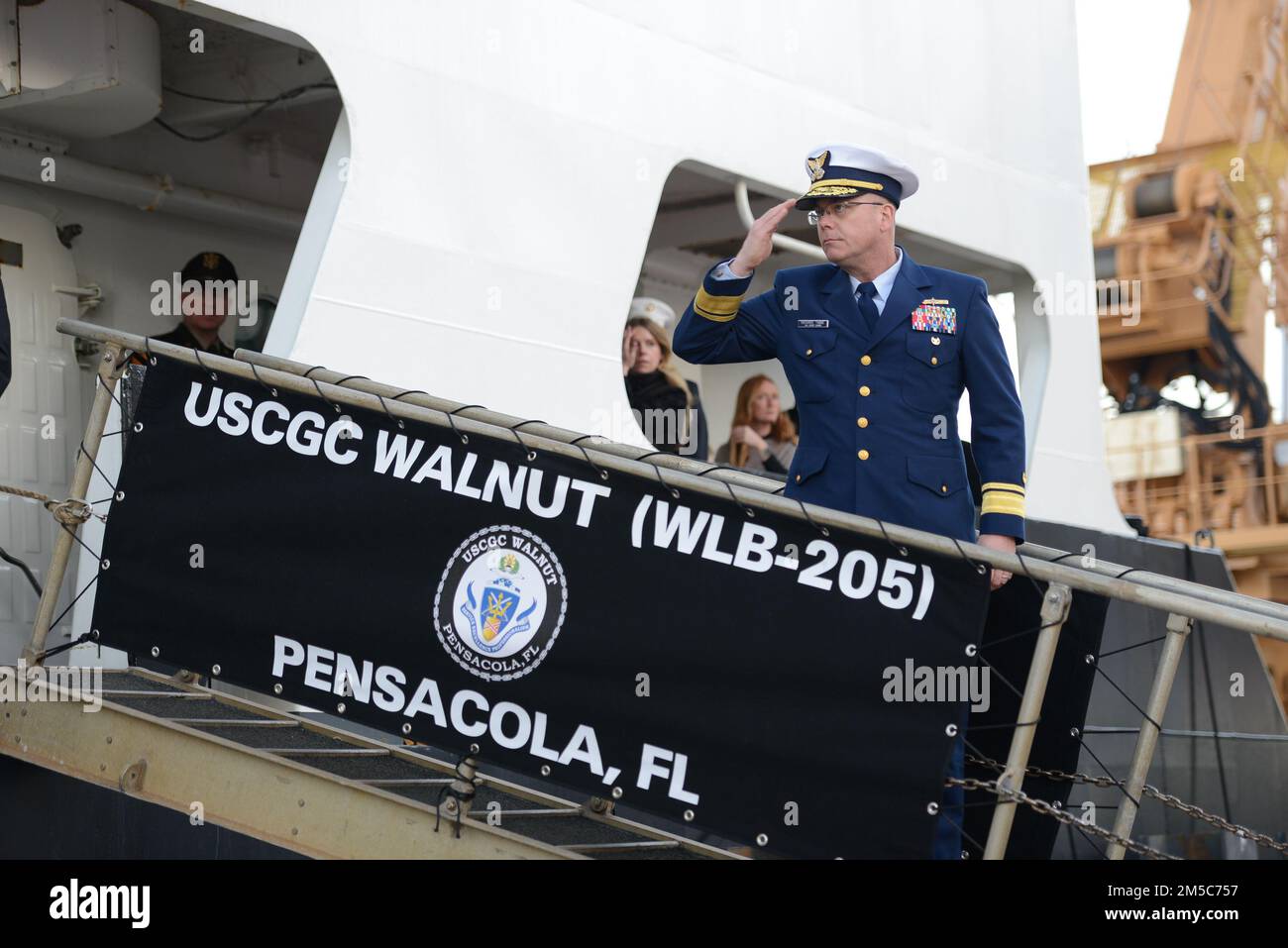 U.S. Coast Guard District Eight commander Admiral Richard Timme salutes ...