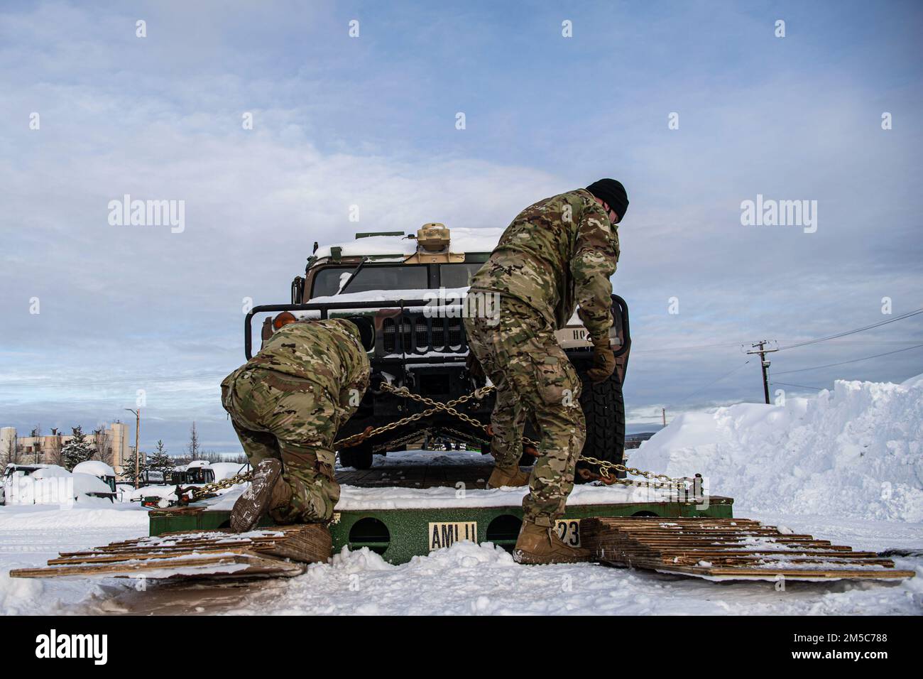 U.S. Army soldiers unload a Humvee in preparation for Exercise Arctic ...