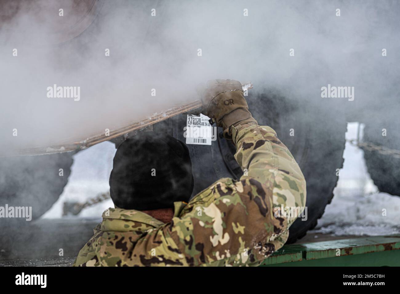A U.S. Army soldier helps start a Humvee in preparation for Exercise ...