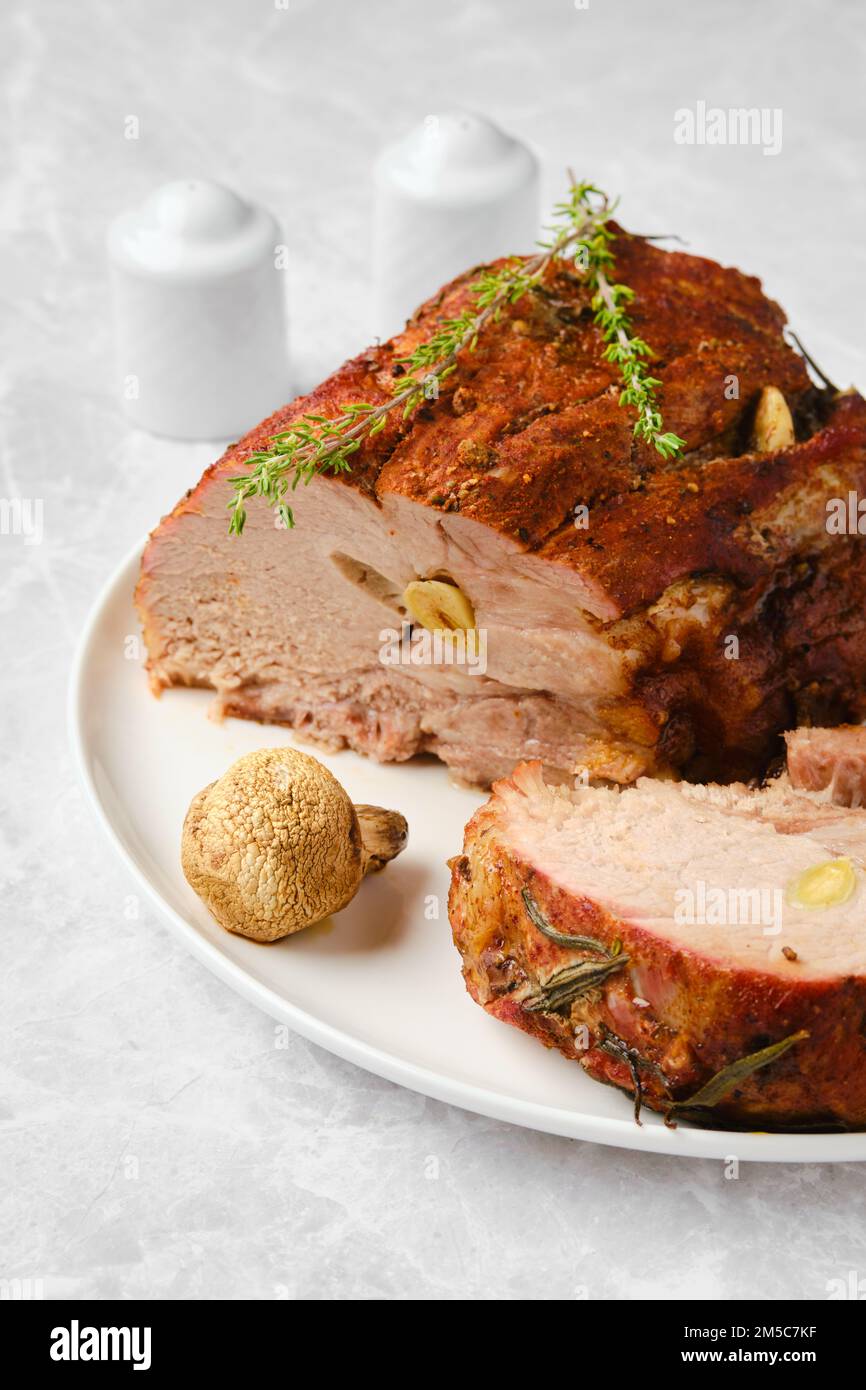 Pork neck baked in oven and cit on slice closeup Stock Photo - Alamy