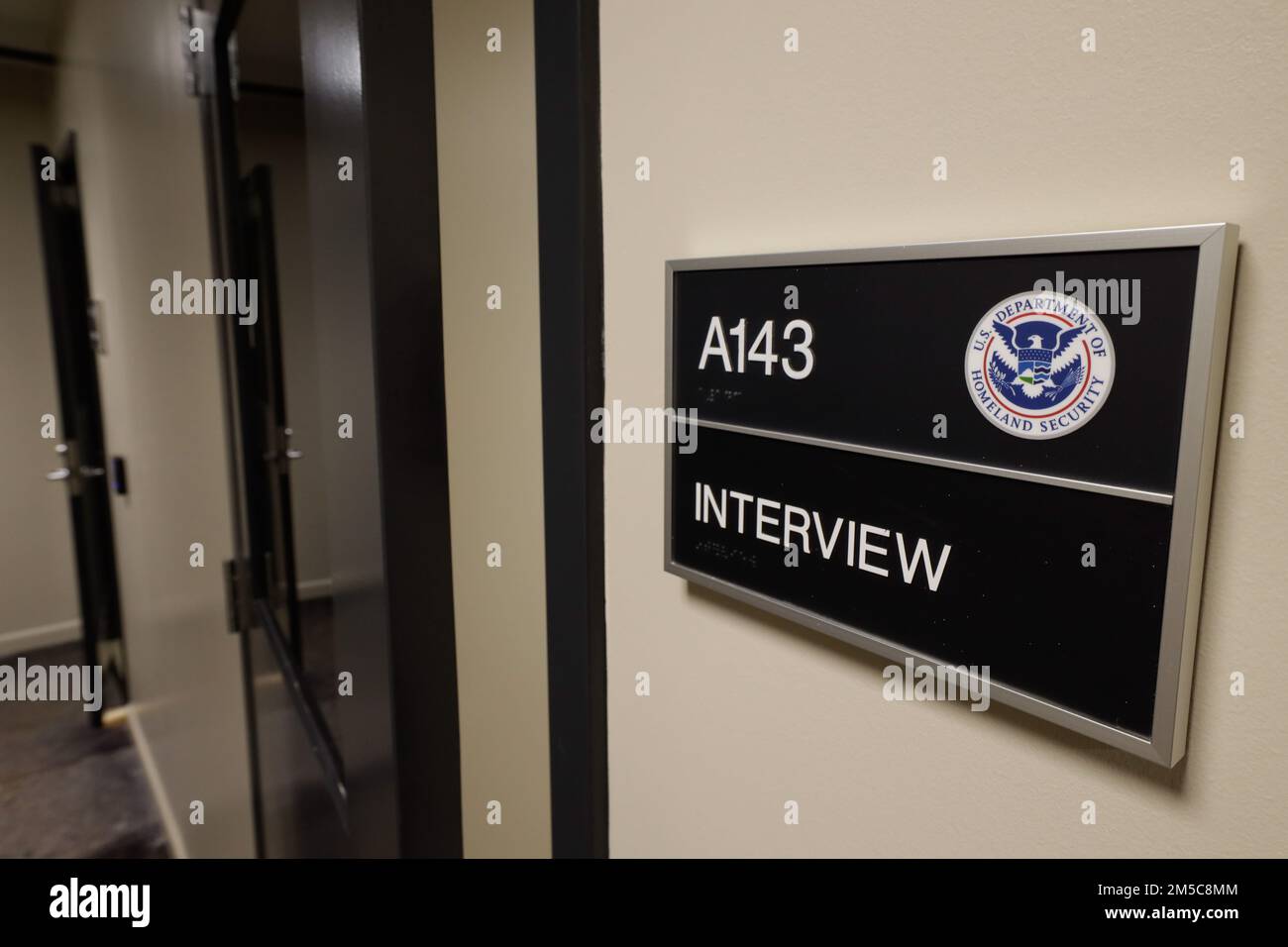 A placard denotes an interview room as U.S. Customs and Border ...