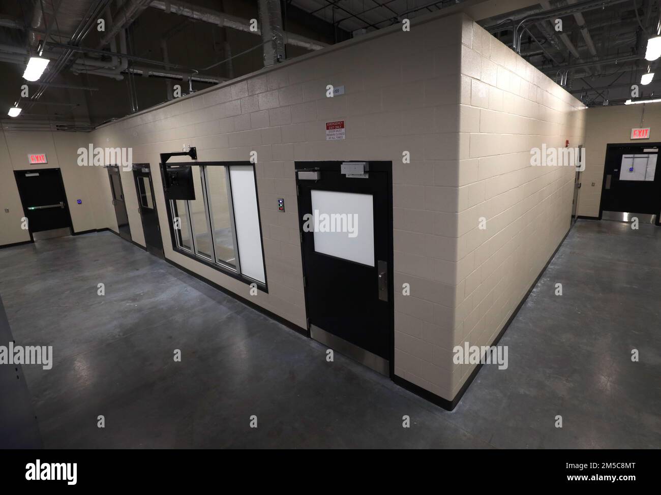 Expansive window panes offer a clear view into migrant detention rooms ...