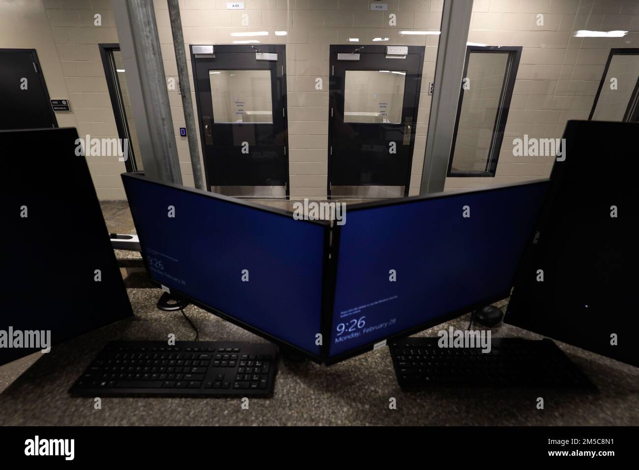 Workstations with protective plexiglass windows are set up to separate ...