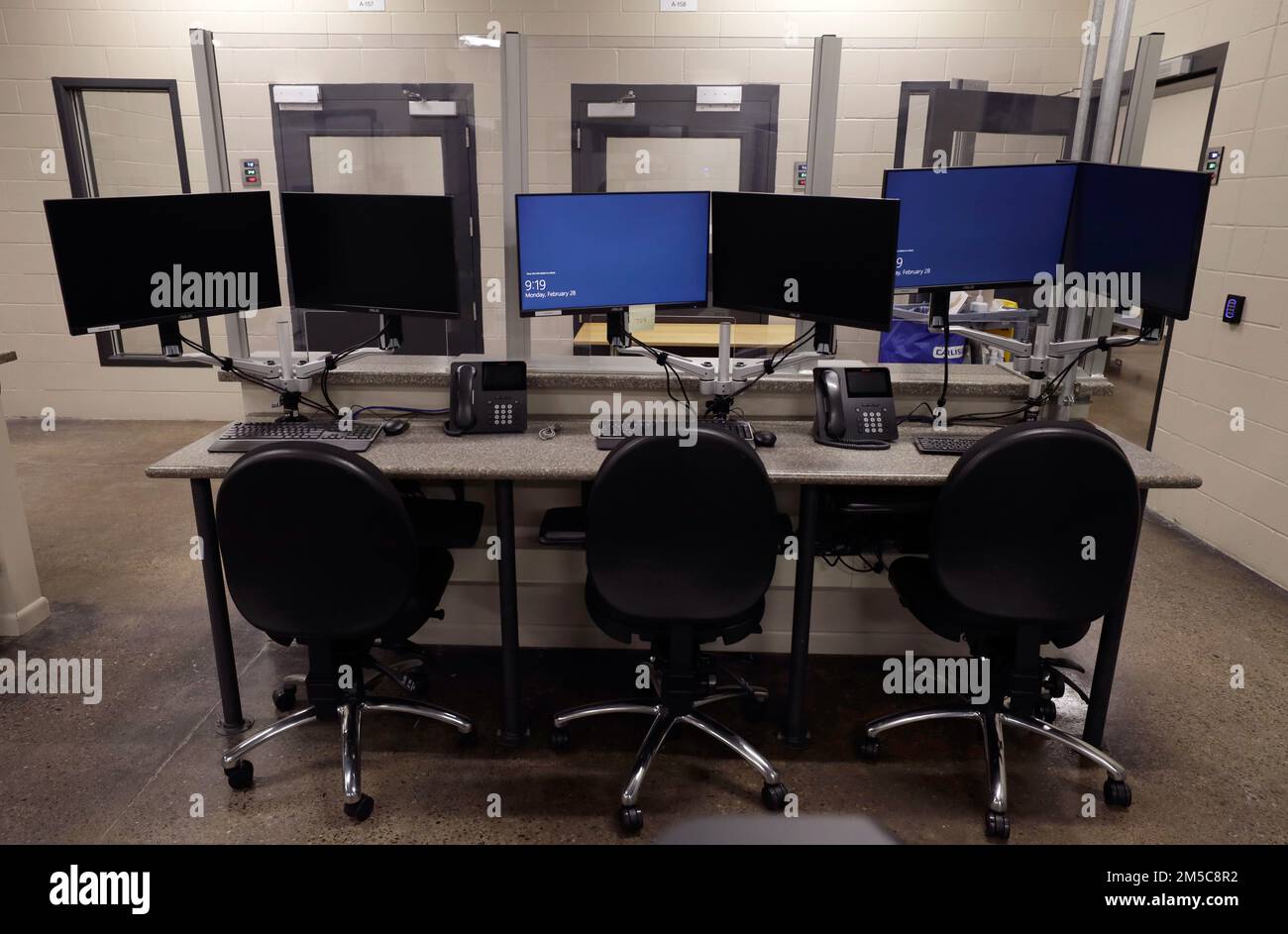 Workstations with protective plexiglass windows are set up to separate ...