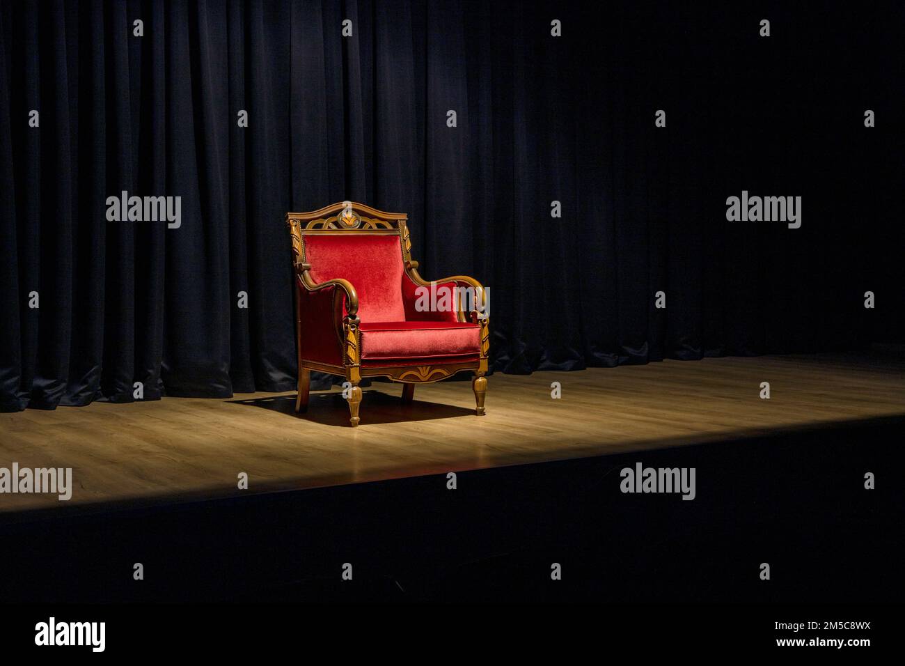Red wooden seat on the theater stage Stock Photo - Alamy