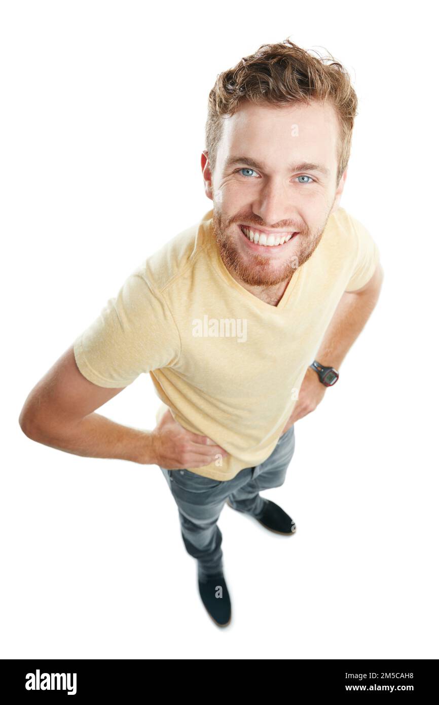 Hello up there. Studio portrait of a young man looking up and smiling ...