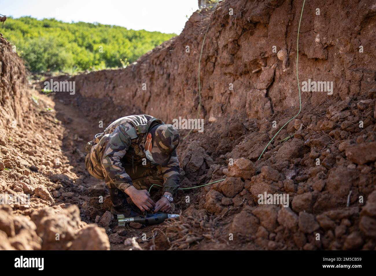 A Royal Moroccan Armed Forces (FAR) soldier sets up an explosive charge ...