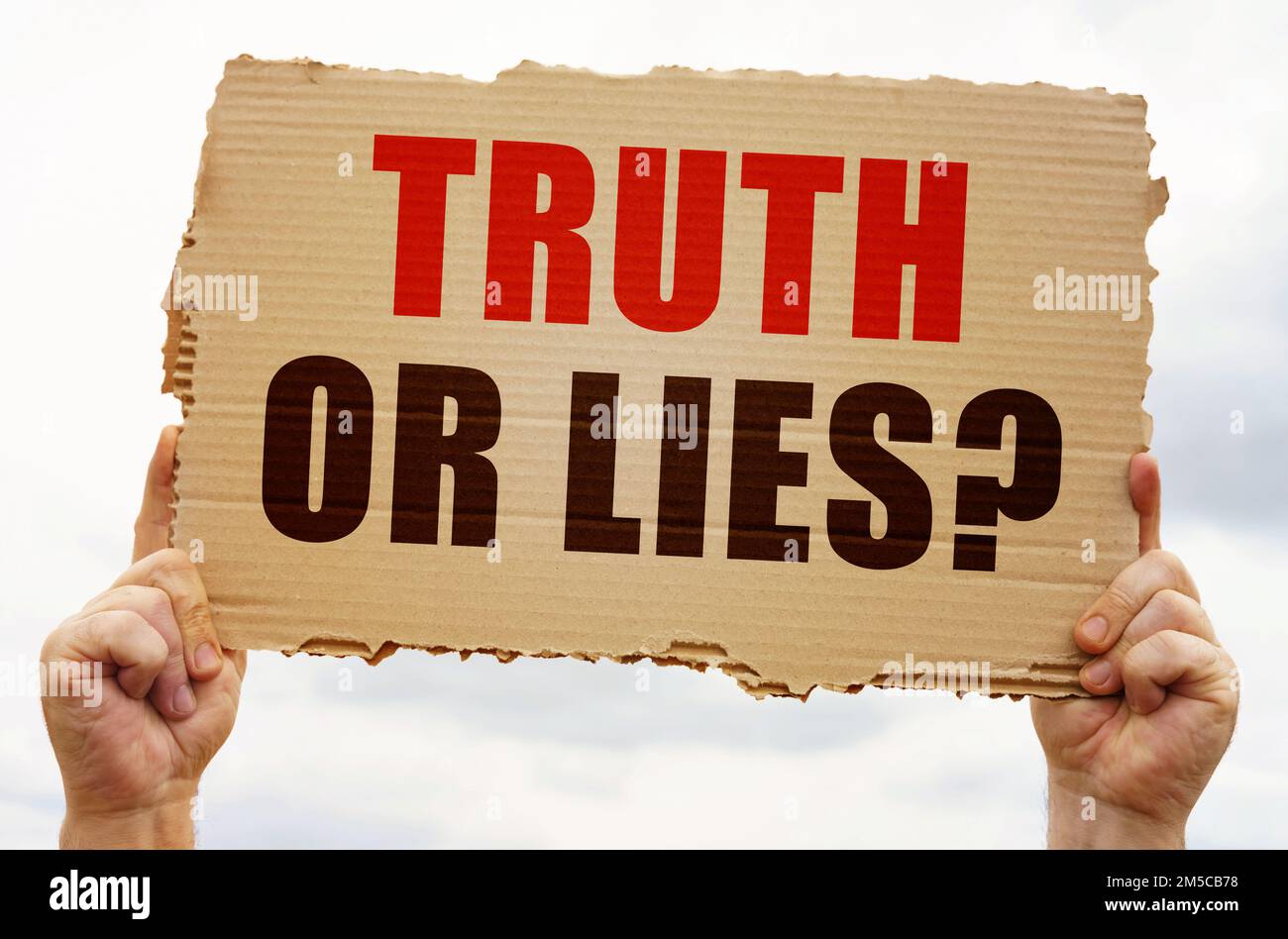 Industrial concept. In the hands of a man is a cardboard sign with the ...