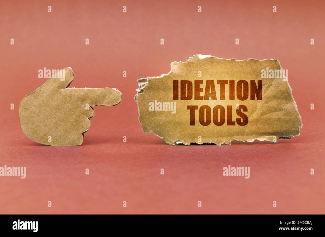 Business and education concept. On a brown surface, a cardboard hand ...