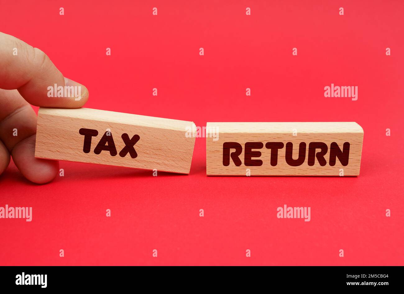 Business concept. On a red background, wooden blocks, one of them in ...