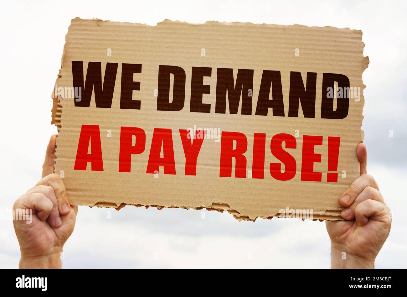 Business concept. In the hands of a man is a cardboard sign with the ...