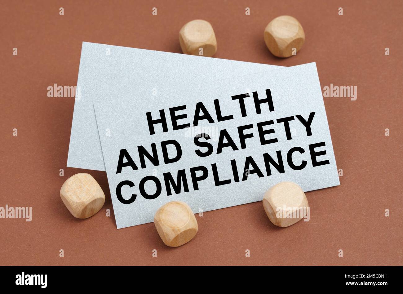 The concept of industrial safety. On a brown surface, wooden cubes and ...