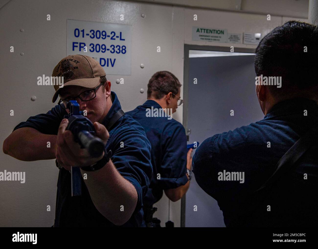 GULF OF OMAN (March 1, 2022) Ensign Jacob Goodman, left, provides cover ...