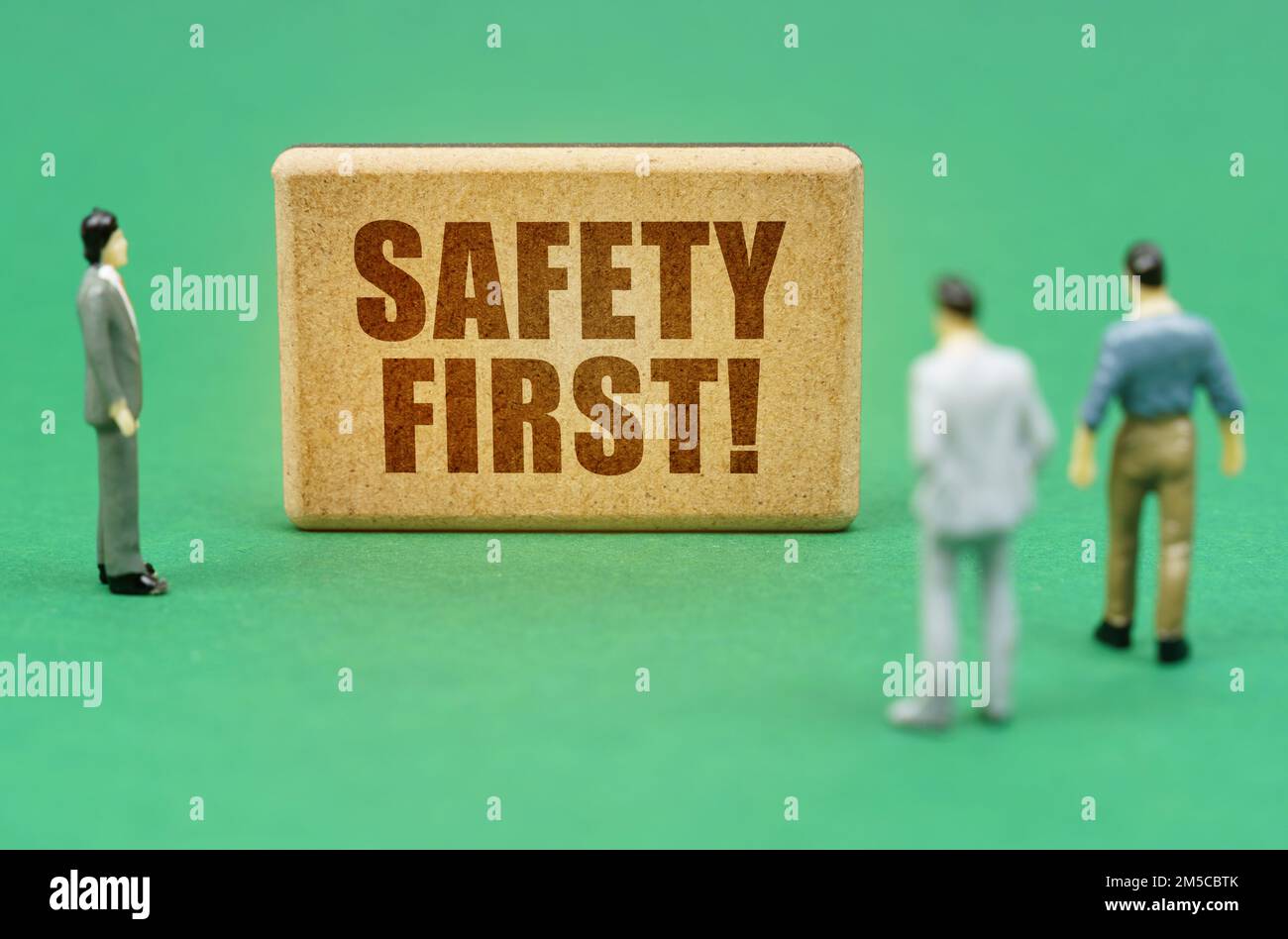 Security and insurance concept. On the green surface are figures of ...