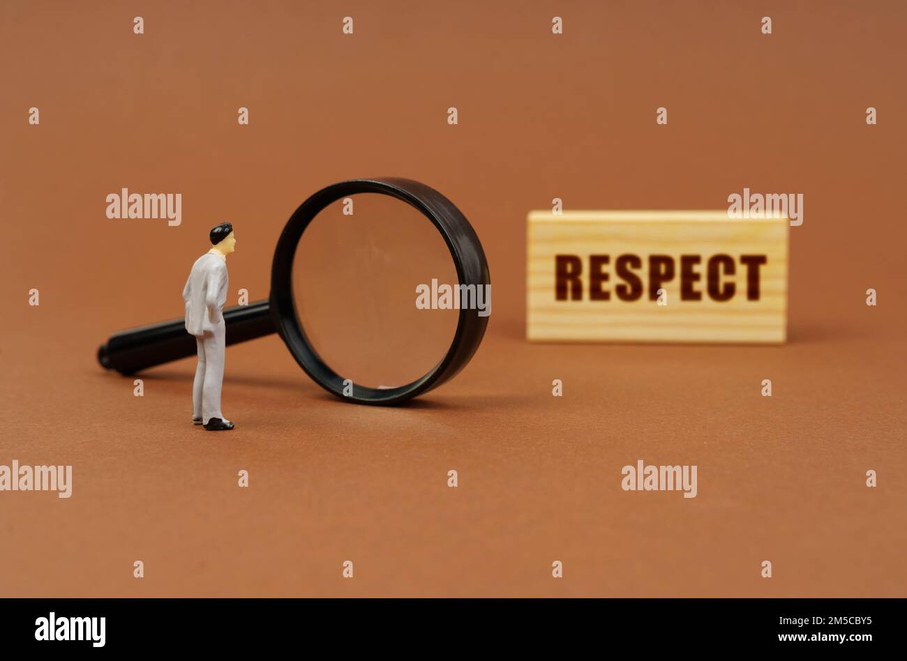 Business concept. A figurine of a businesswoman looks through a ...