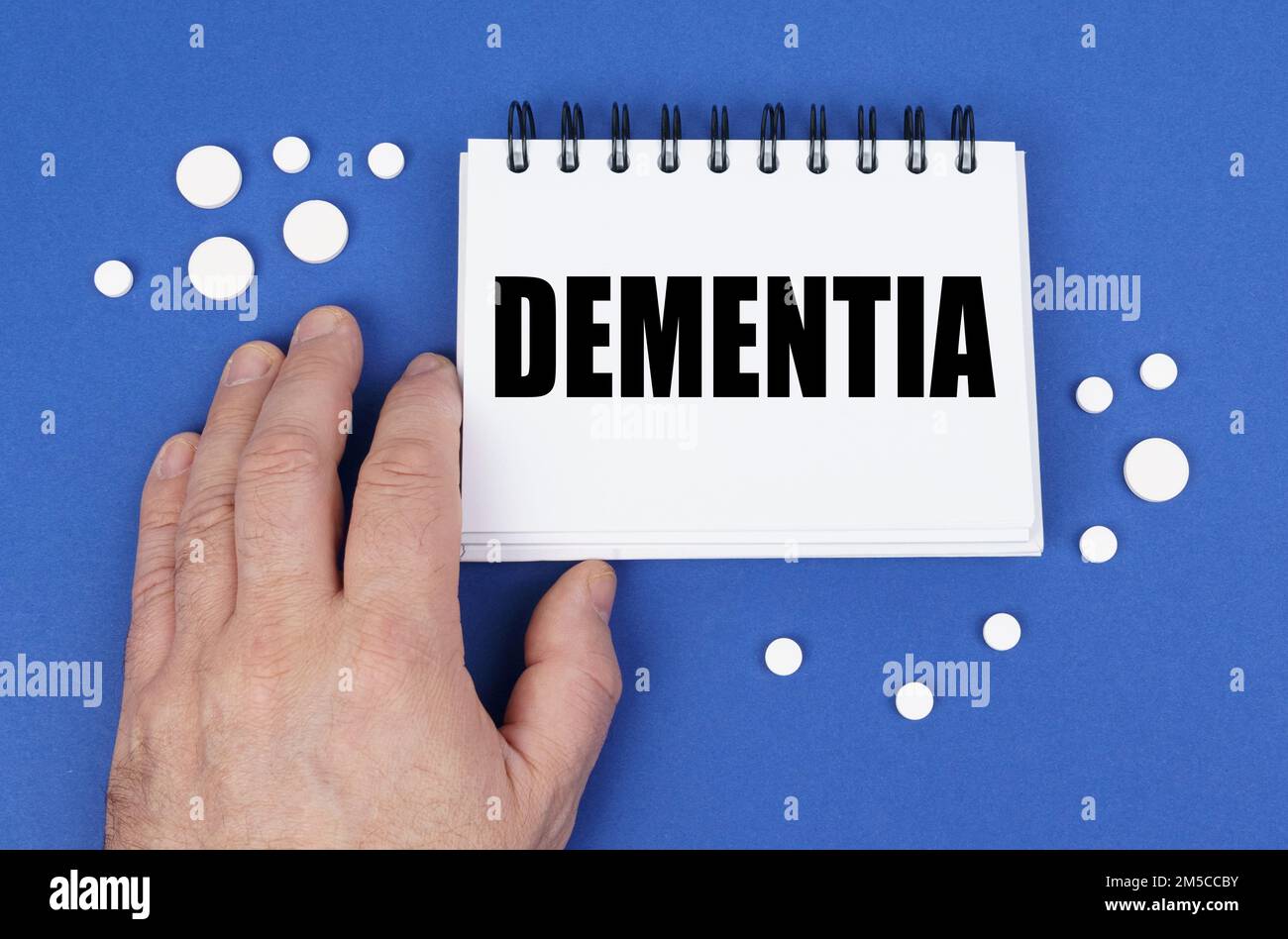 Medical concept. On the blue surface of the tablet, a hand and a ...