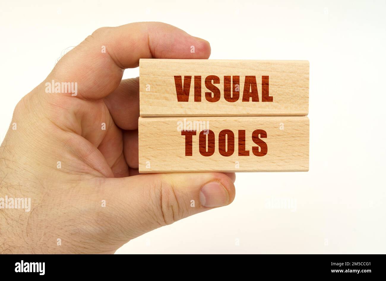 Business concept. On a white background, a hand that holds wooden ...