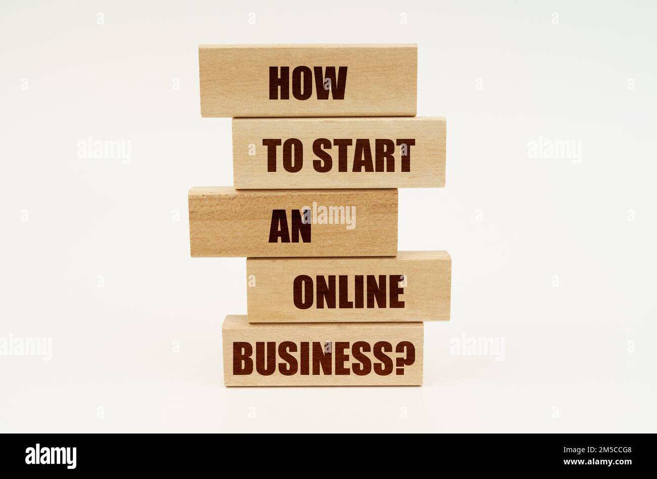 Business concept. On a white surface are wooden blocks with the ...