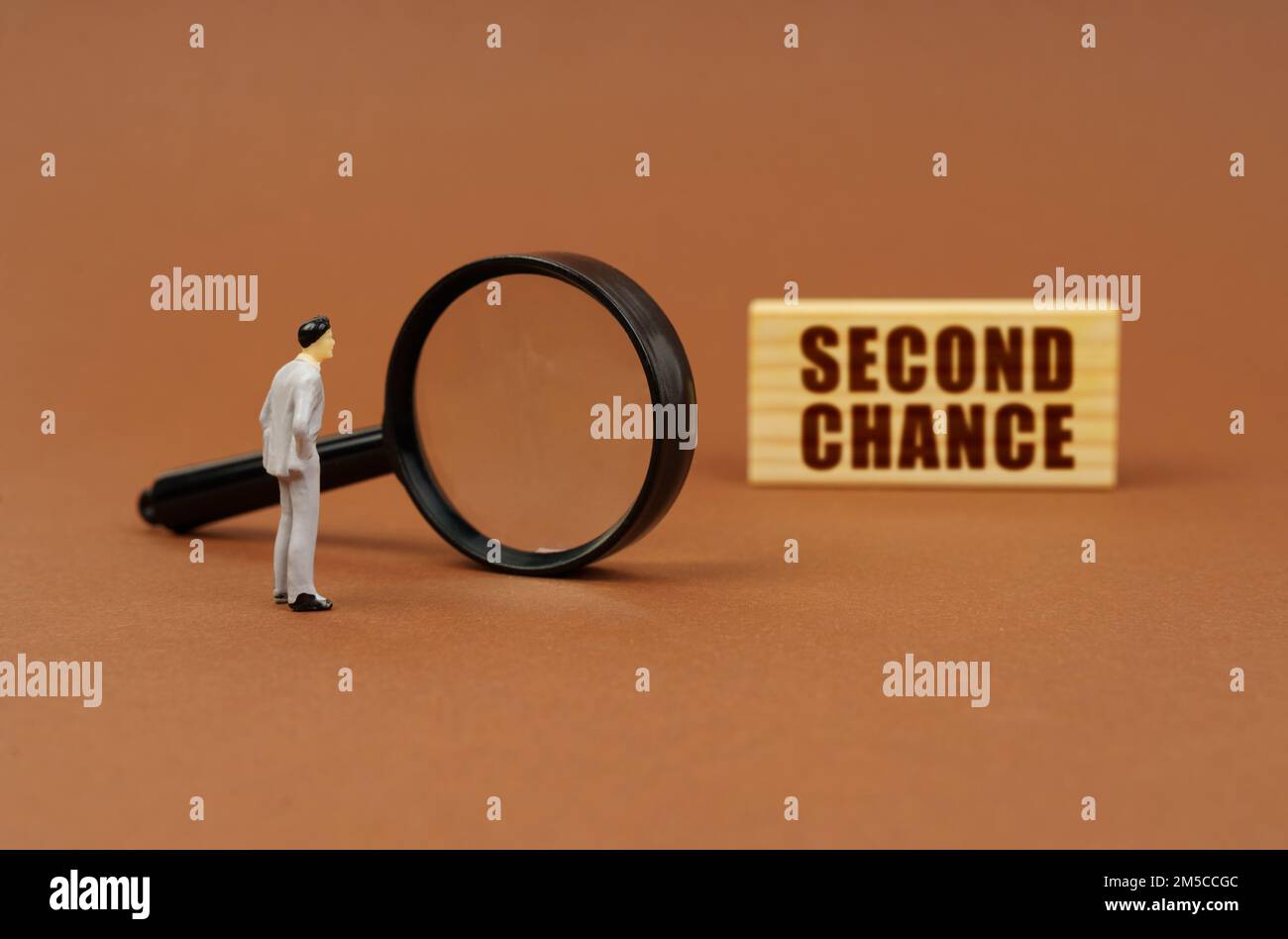 Business concept. A figurine of a businesswoman looks through a ...