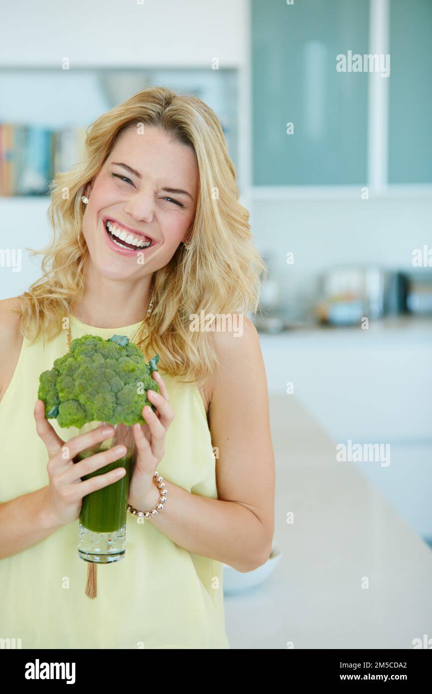 Get all your greens in one glass. Portrait of a happy young woman ...