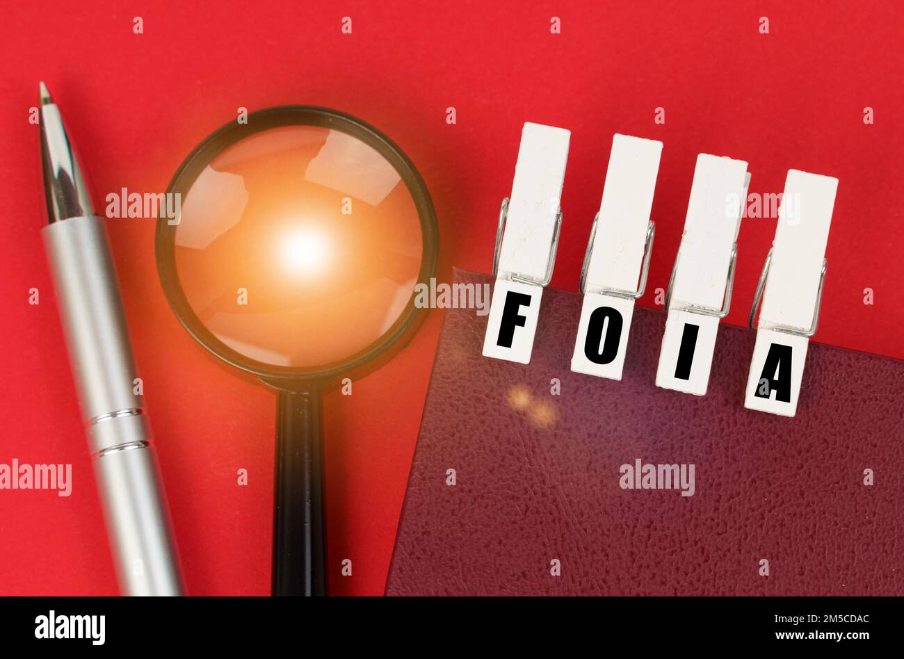 Business concept. On the red surface there is a magnifying glass, a ...