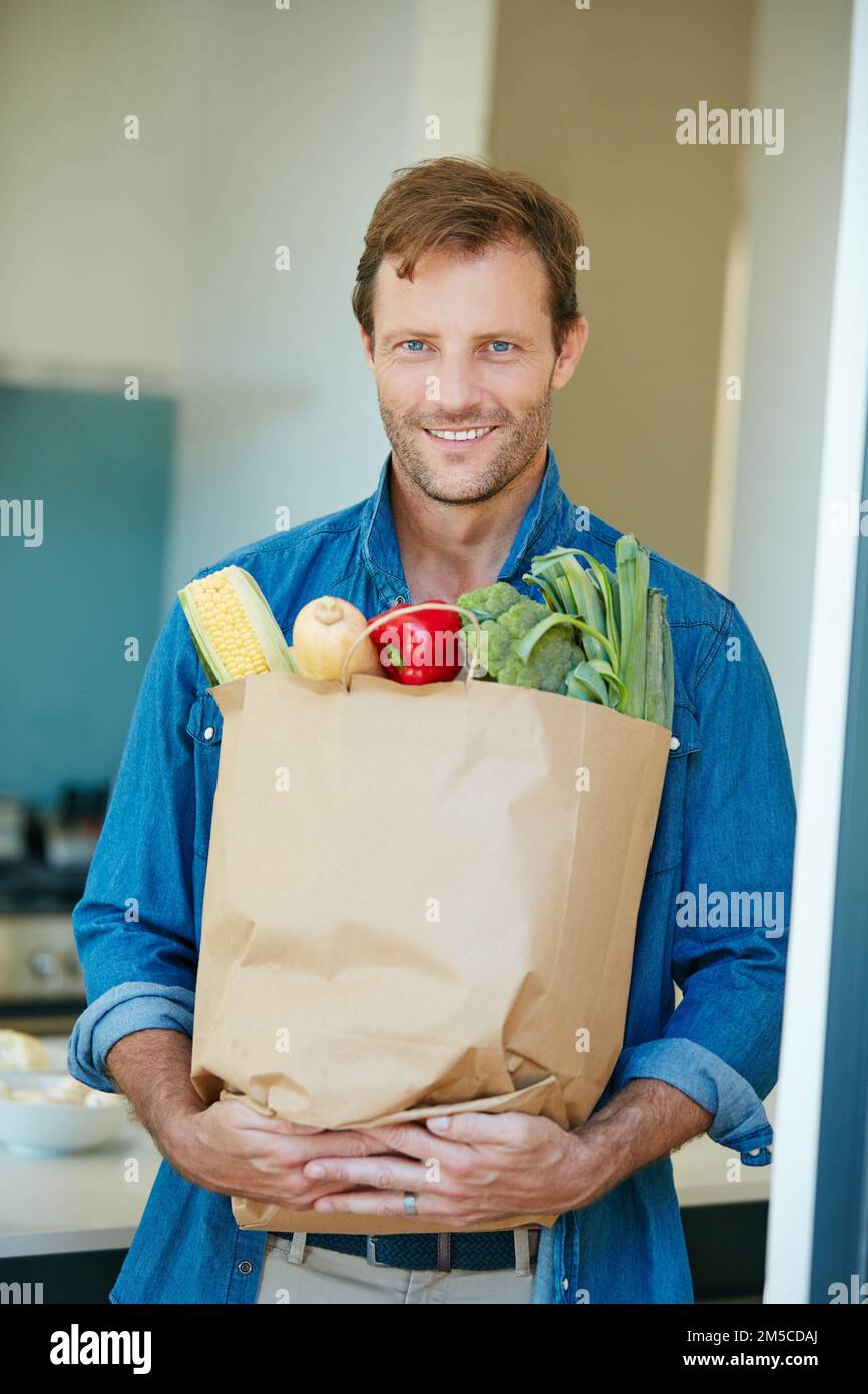 Fresh from Mother natures pantry. Portrait of a happy man holding a bag ...