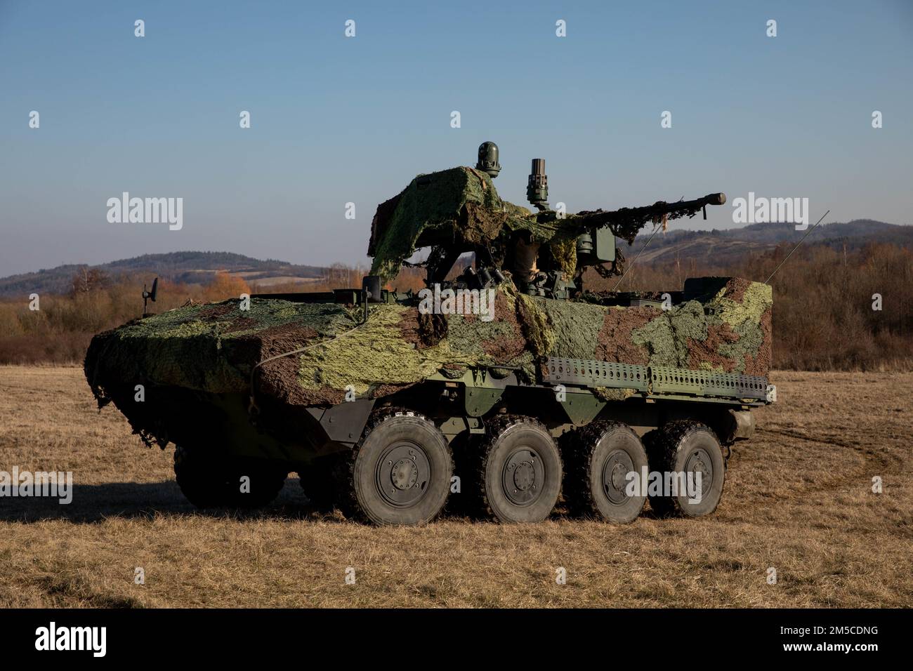 Members of the Czech Army traverse a field in a Pandur II Armored ...