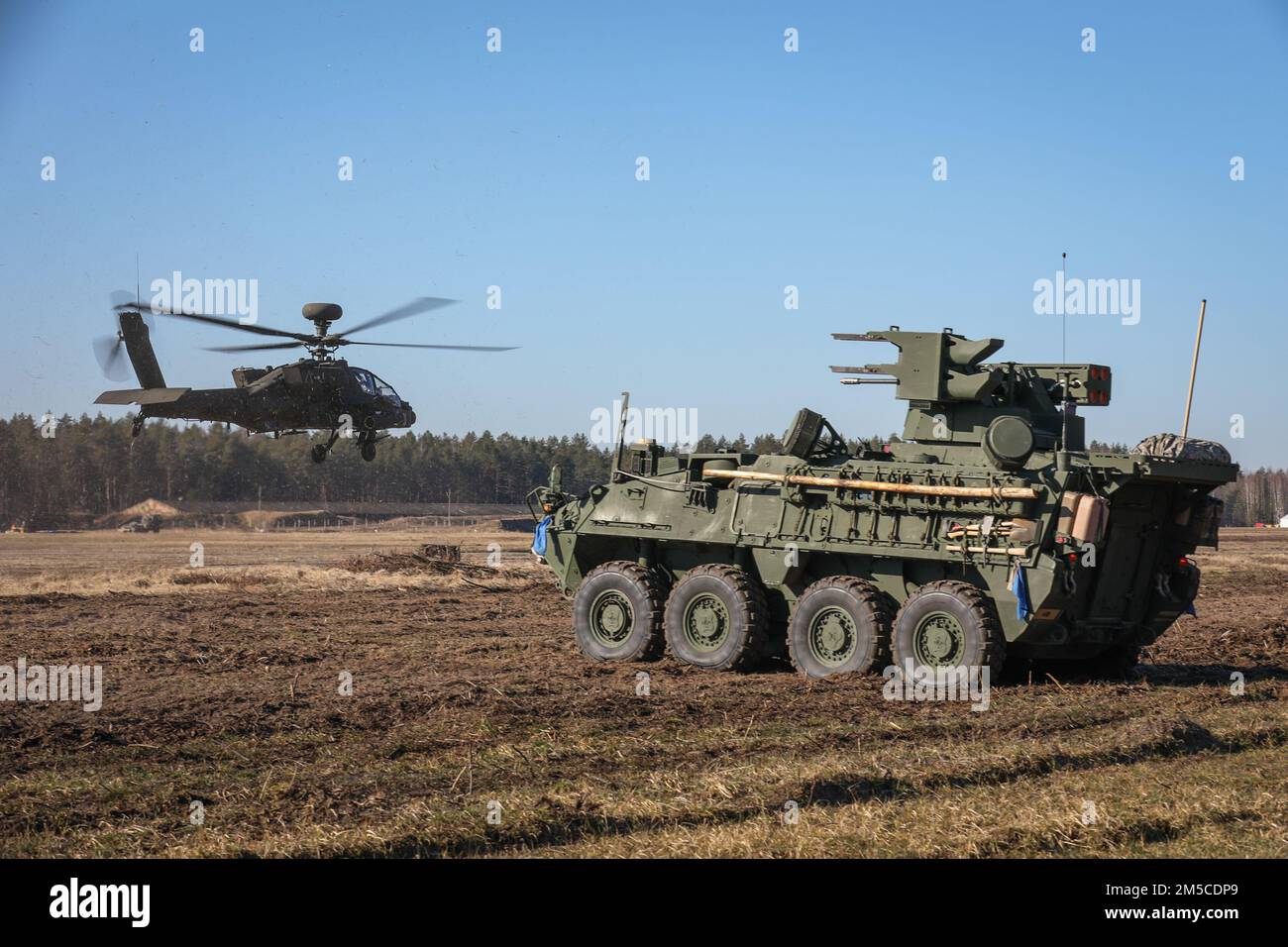 A U.K. Army Apache assigned to 664 Squadron flies beside a Maneuver ...