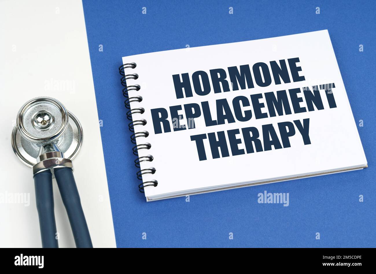 Medical concept. On a blue-white surface lies a stethoscope and a ...