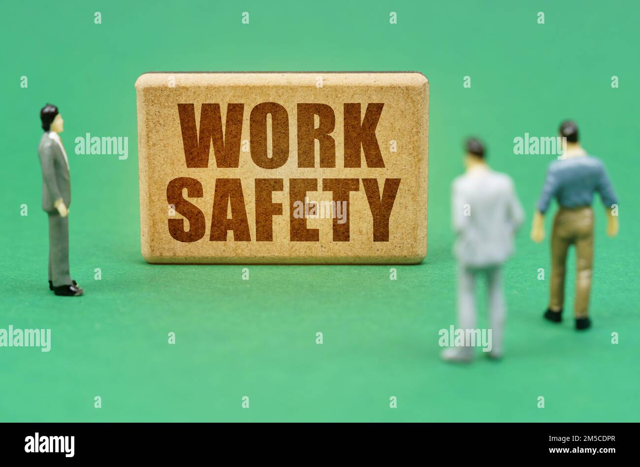 Security and insurance concept. On the green surface are figures of ...