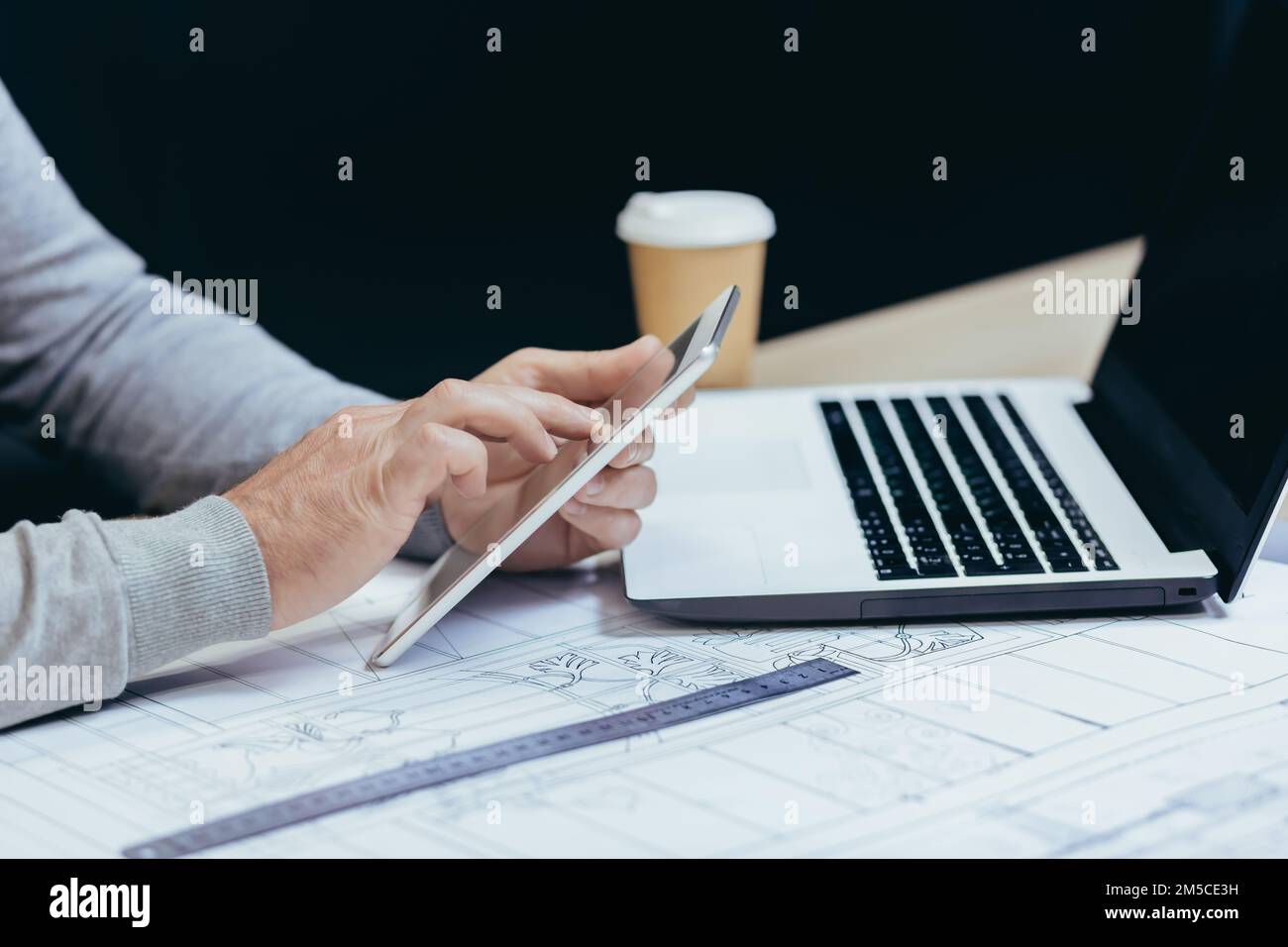 Close-up photo of hands of male designer architect working with tablet ...