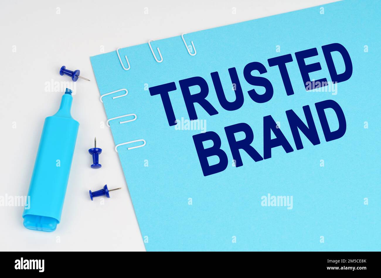 Economic concept. On a white surface, a marker, buttons and a blue ...