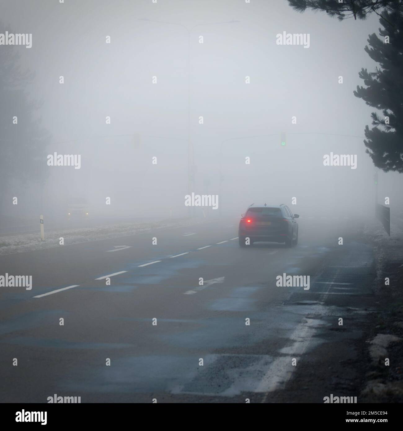 Bad weather driving - foggy hazy country road. Motorway - road traffic ...