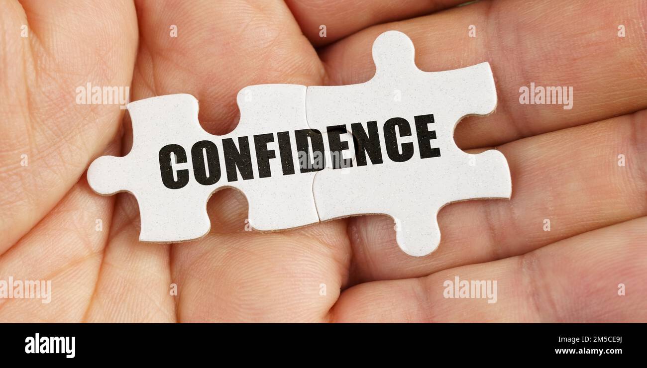 Business concept. In the hand of a man are puzzles with the inscription ...