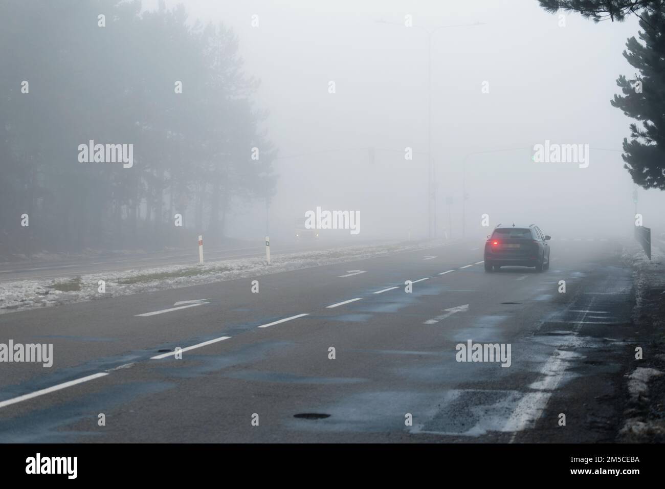 Cars in the fog. Bad winter weather and dangerous automobile traffic on ...