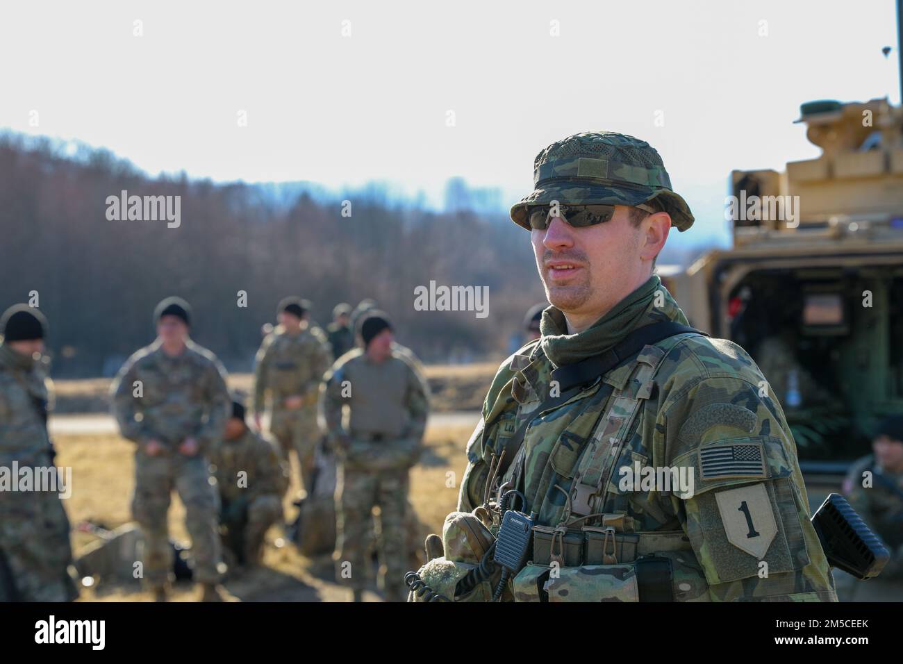 A soldier with the army of the Czech Republic watches vehicle maneuvers ...