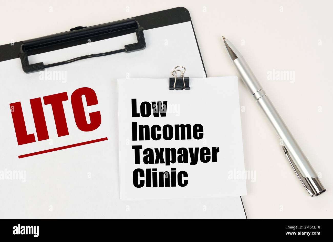 Business concept. On the tablet is a sheet of paper with the inscription - LITC and stickers ...