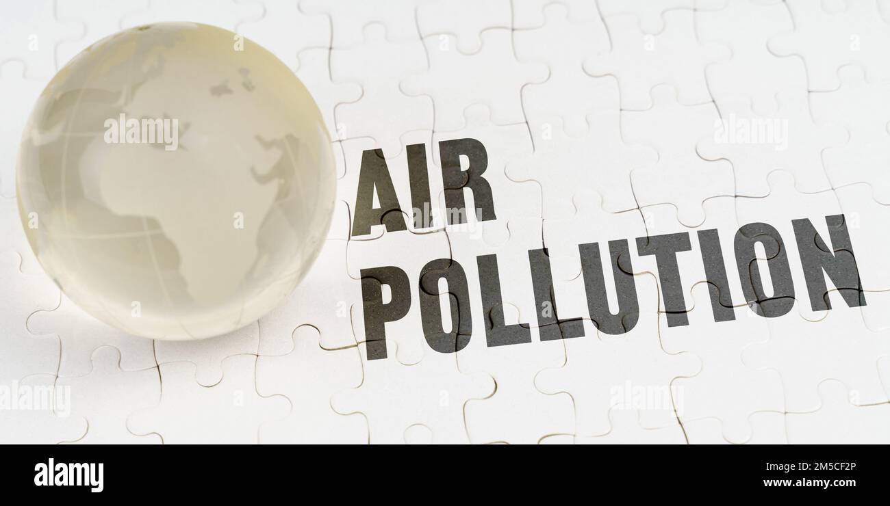 Ecological concept. On white puzzles there is a glass globe and the ...